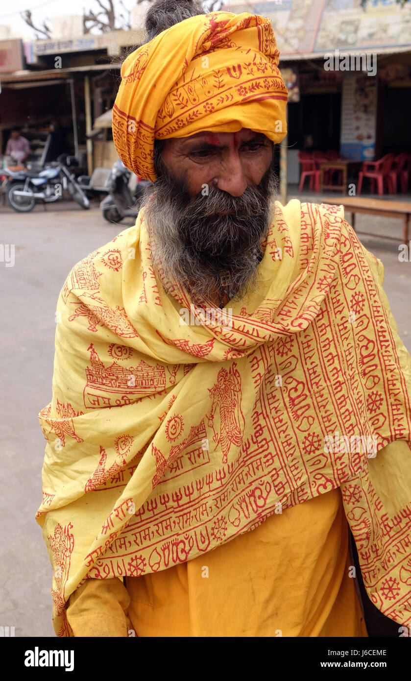 An unidentified Indian sadhu holy man walking at the bazaar and collect ...