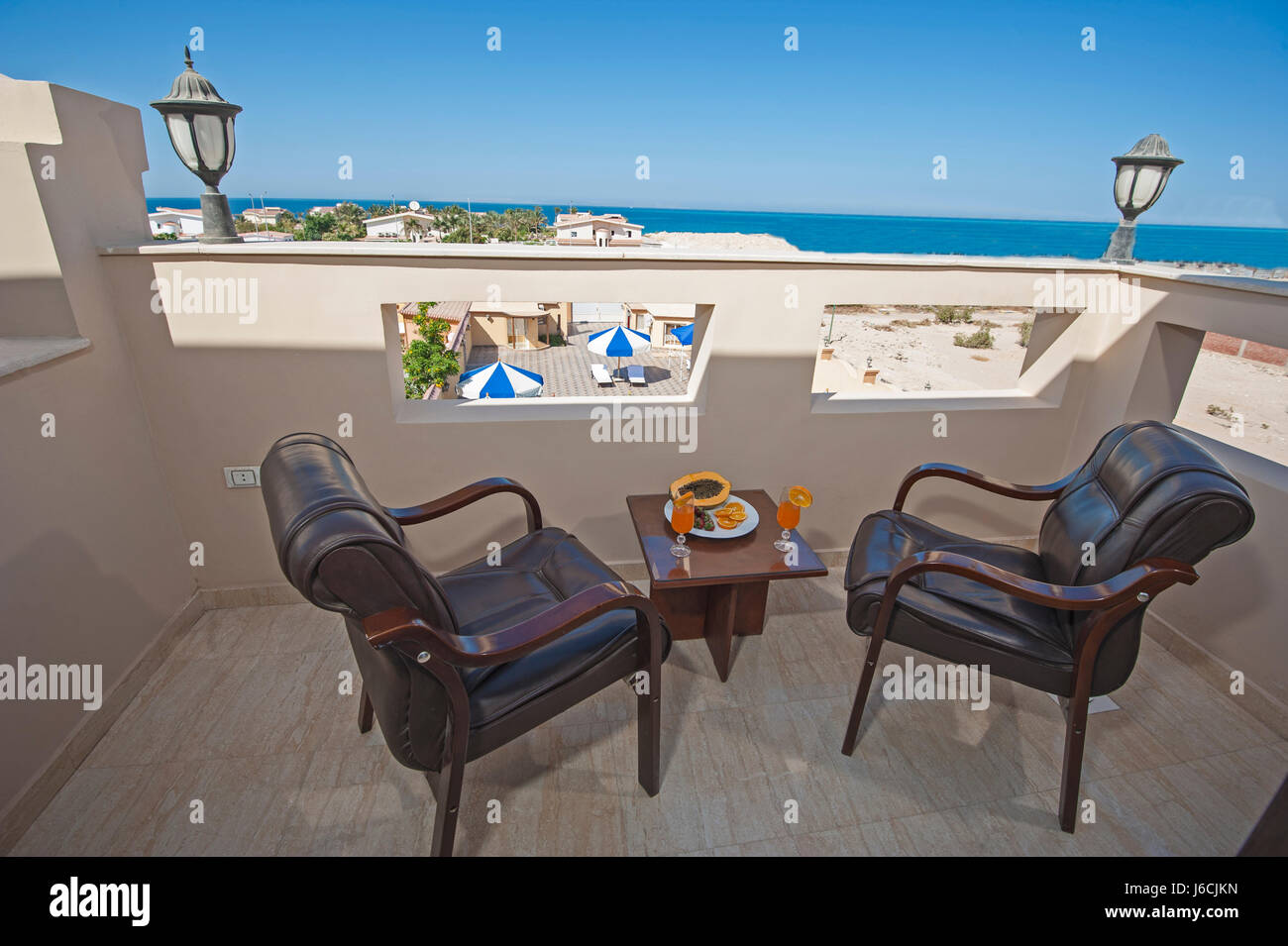 View over tropical sea from luxury tropical resort balcony with table ...
