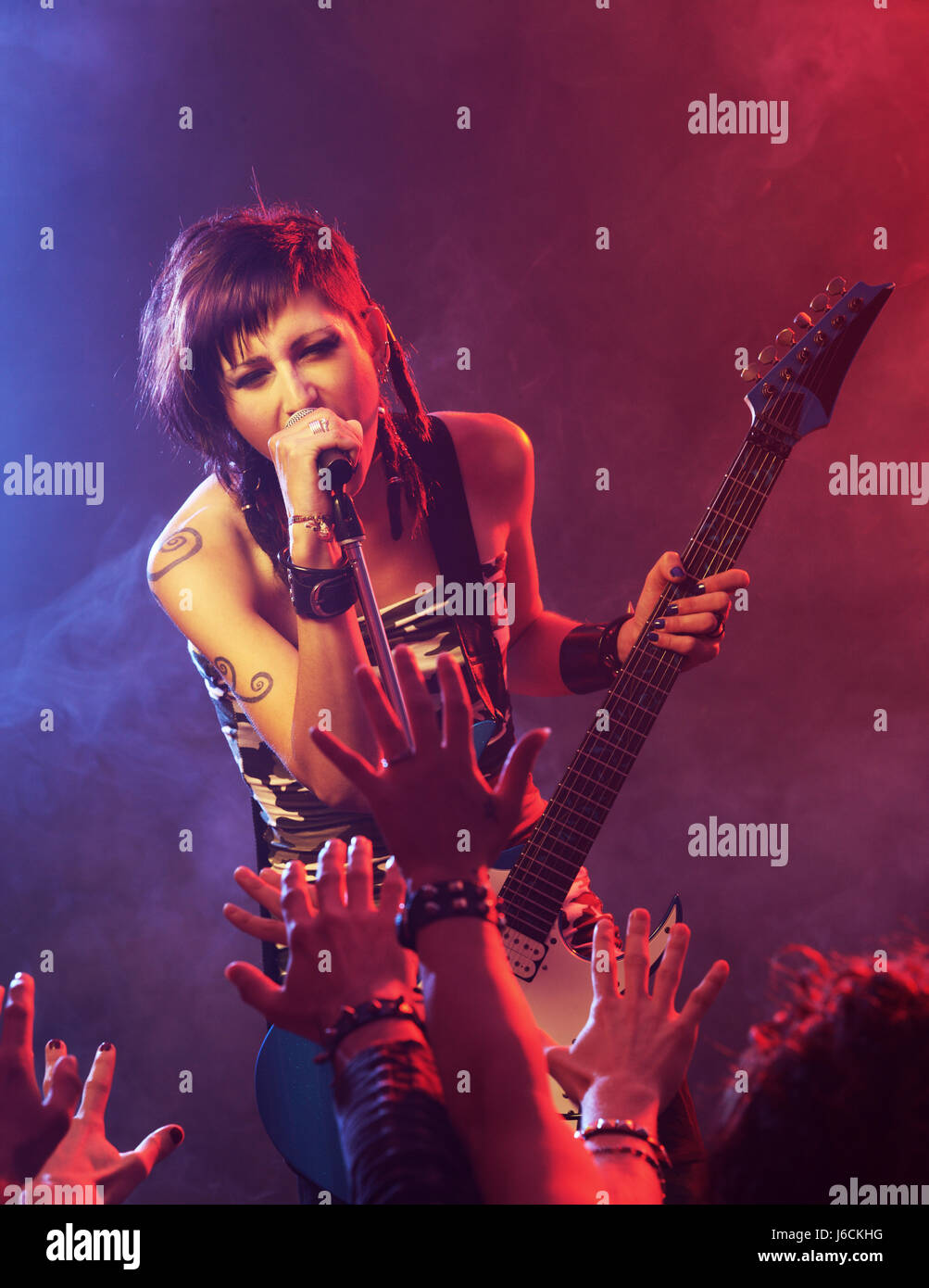 Female singer and guitarist at a rock concert Stock Photo - Alamy