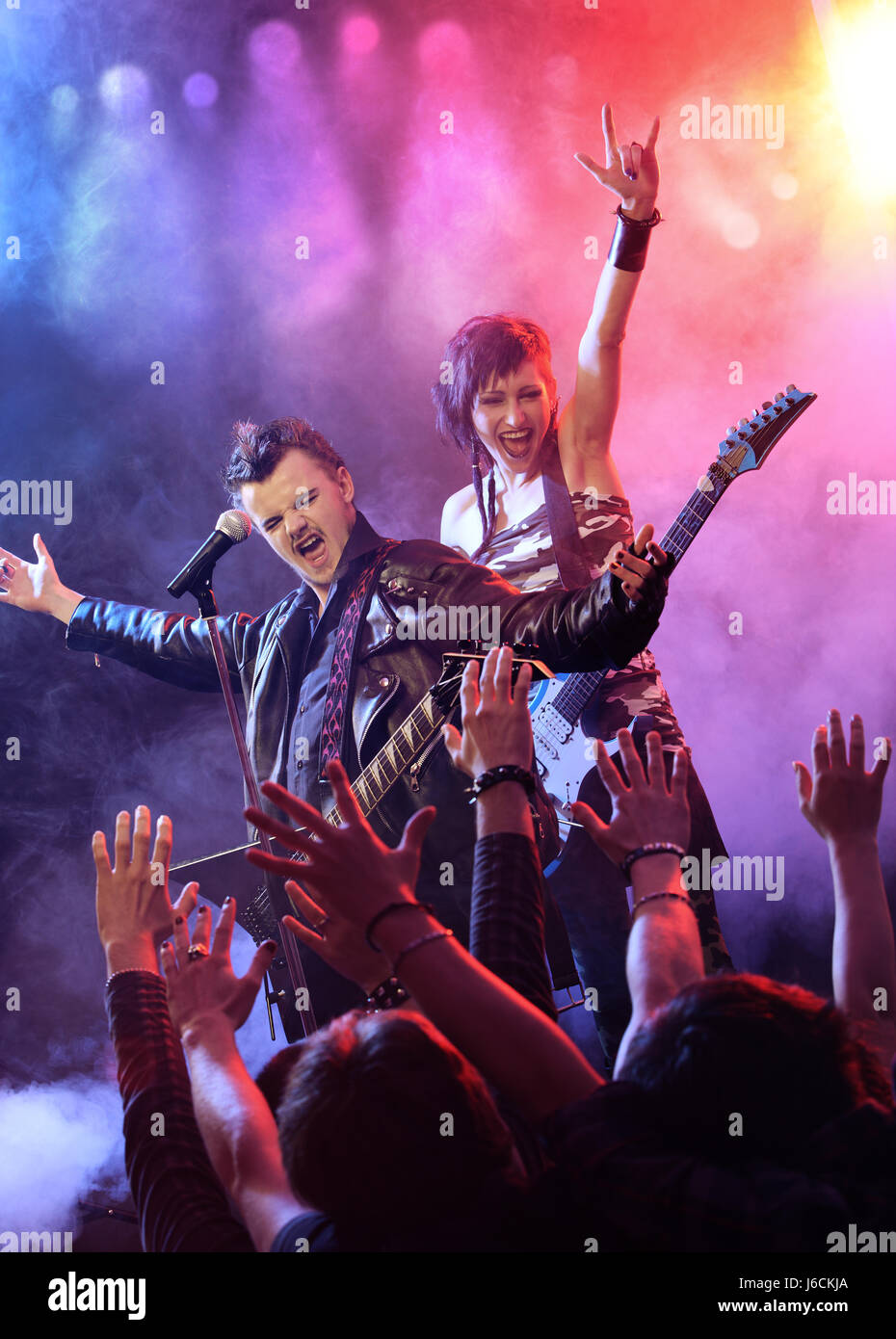 Singer and guitarist rocking out with the crowd enjoying it Stock Photo ...