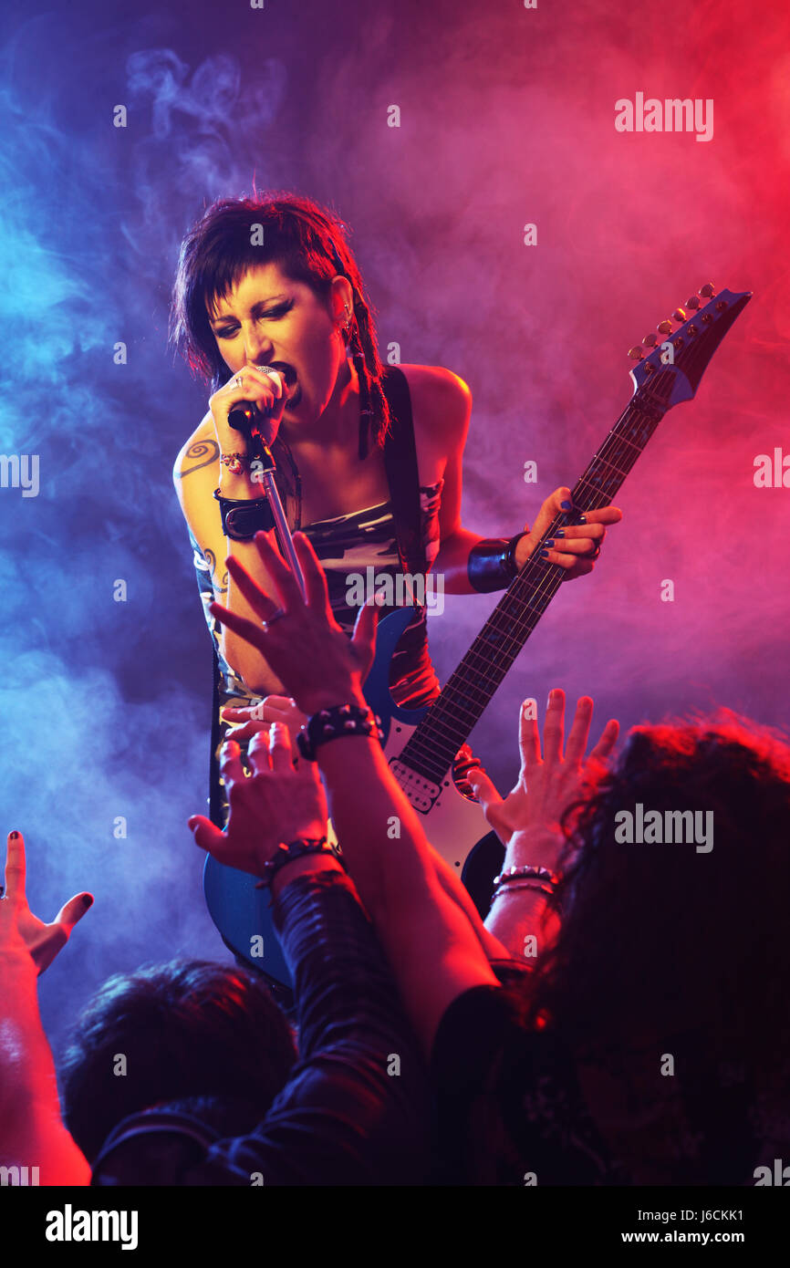 Female singer and guitarist at a rock concert Stock Photo - Alamy