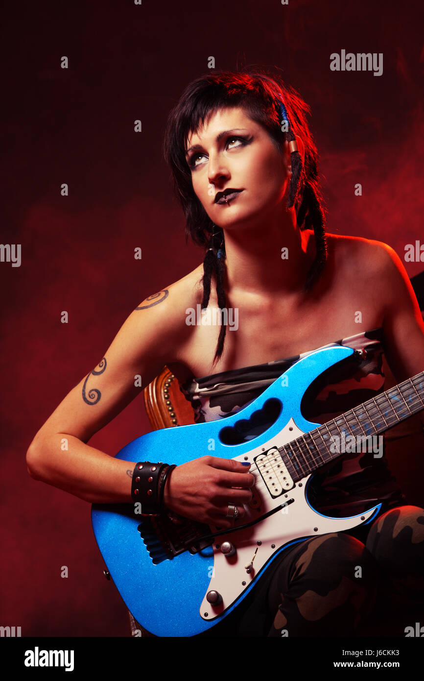 Female guitarist playing guitar at a rock concert Stock Photo - Alamy