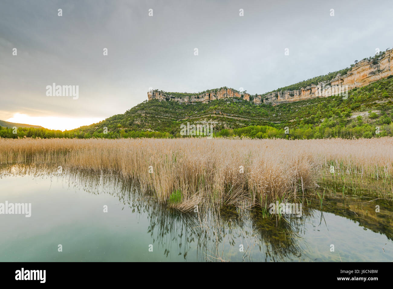 mirror reflection of hills in lake Stock Photo - Alamy