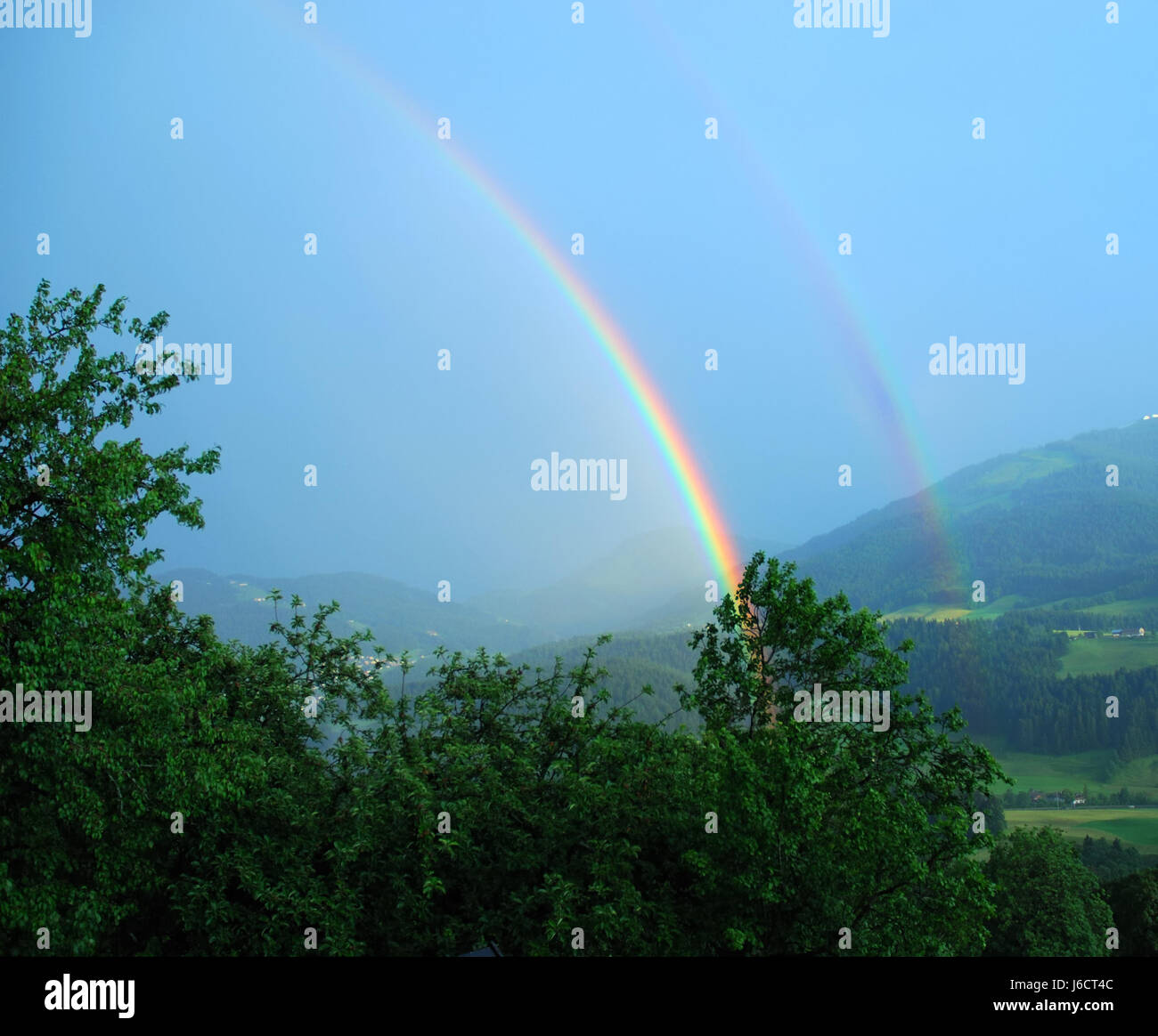 rainbow weather storm rainy rain gale wind raining tree trees mountains ...