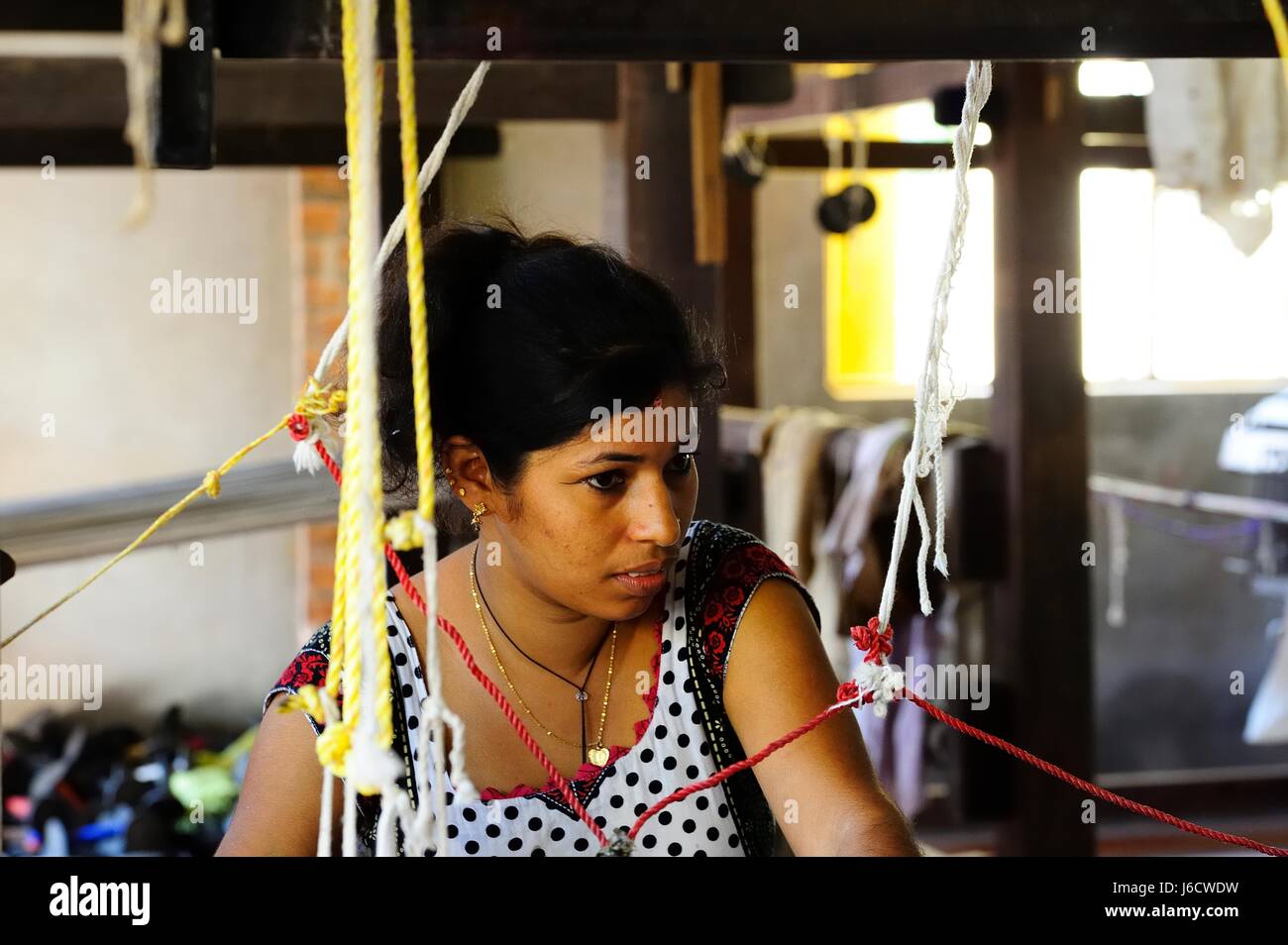 Young lady weaving on a loom Stock Photo - Alamy
