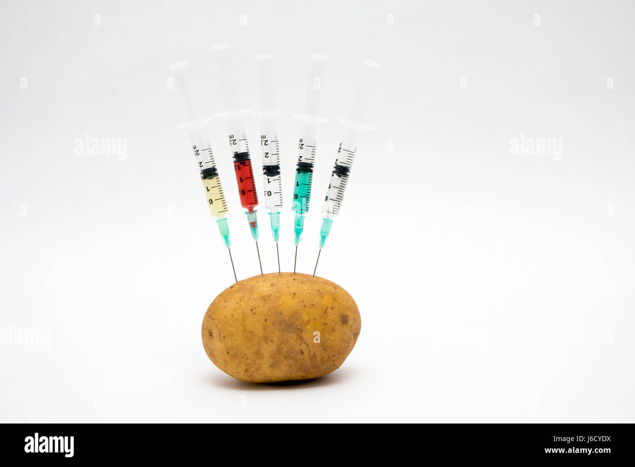 GMO concept on white background with syringes and potato Stock Photo ...