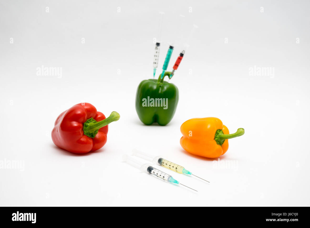 GMO concept on white background with syringes and peppers Stock Photo ...