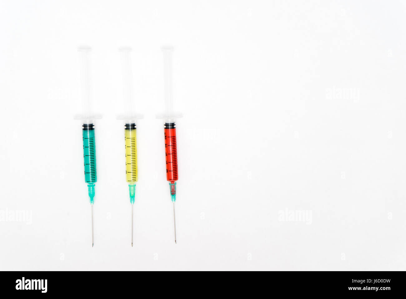 Medical colorful syringes isolated on white background Stock Photo - Alamy