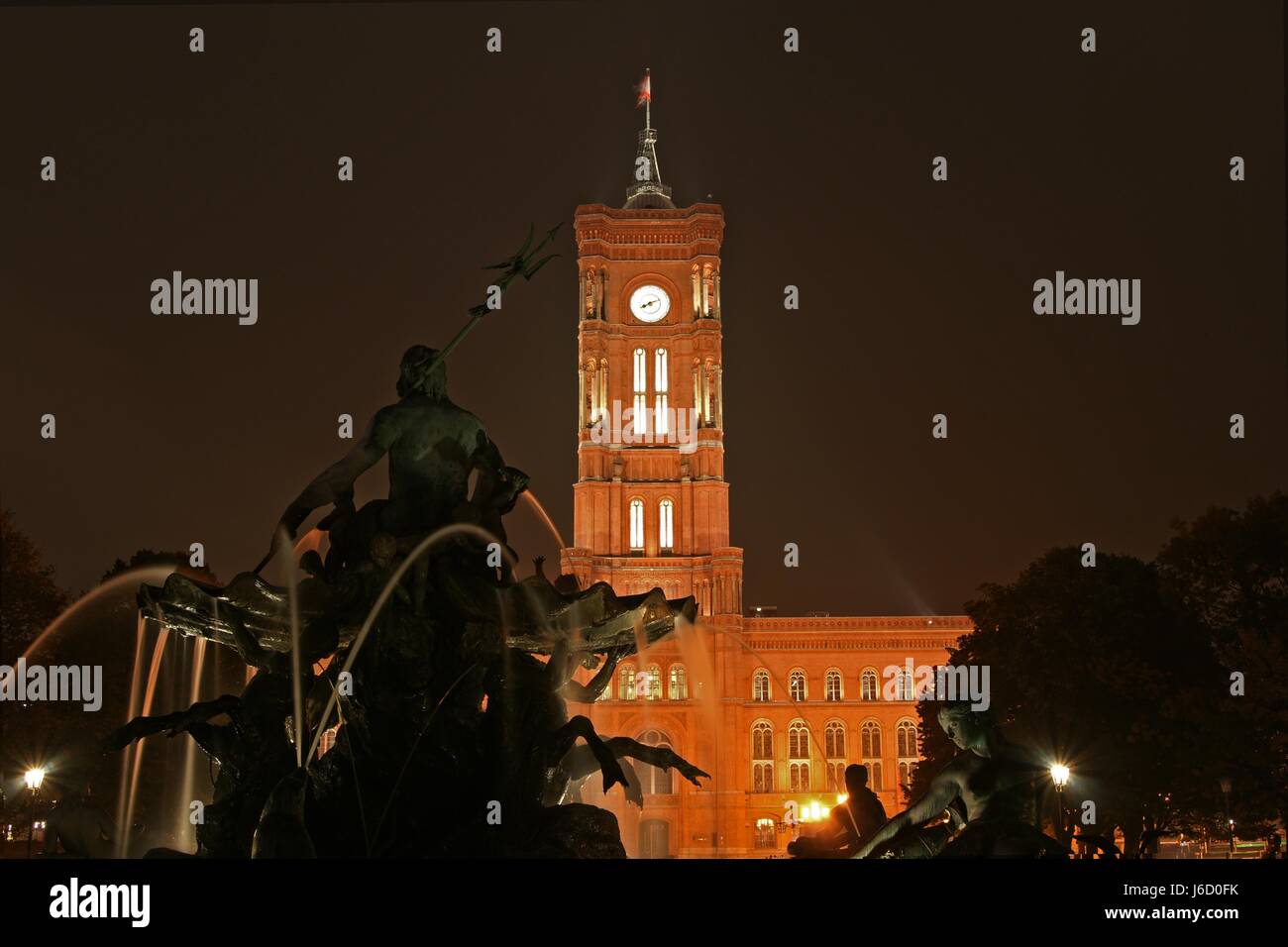 neptune fountain in front of the red town hall Stock Photo - Alamy