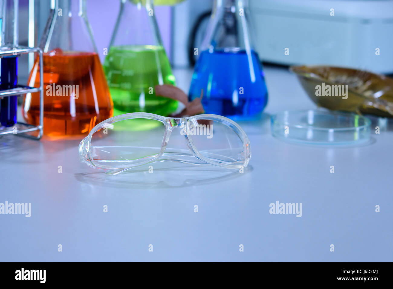 Glasses and scientific experiments in laboratory Stock Photo - Alamy