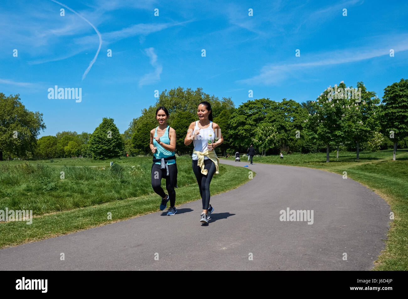 Two young women running in Regent's Park, London, England, United ...