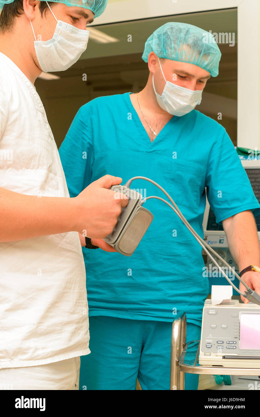Anesthesiologists in the operating room before surgery preparing the ...