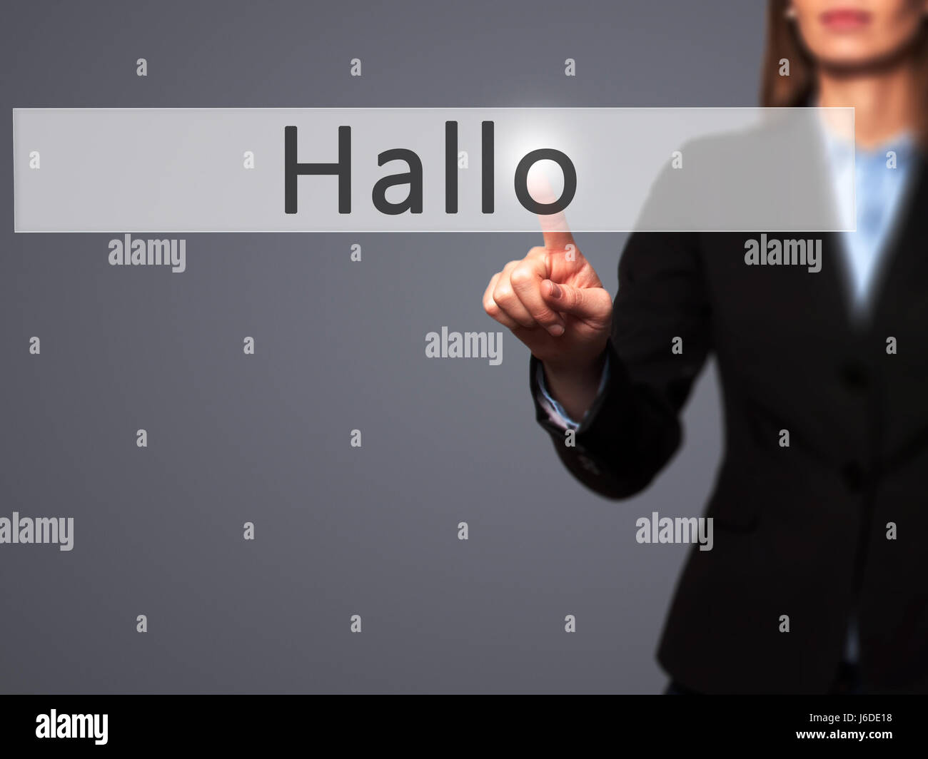 Hallo (Hello in German) - Businesswoman hand pressing button on touch ...