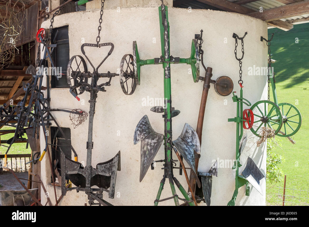 agricultural tools on barn wall Stock Photo - Alamy