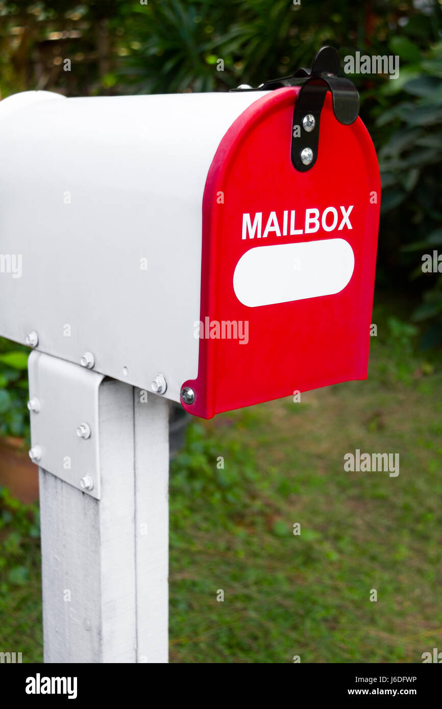 Red and white mail box in green garden Stock Photo - Alamy