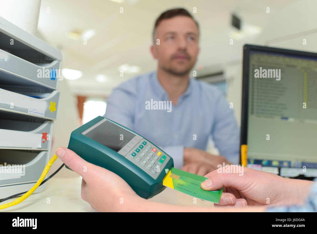 Medical woker putting health card into electronic reader Stock Photo ...