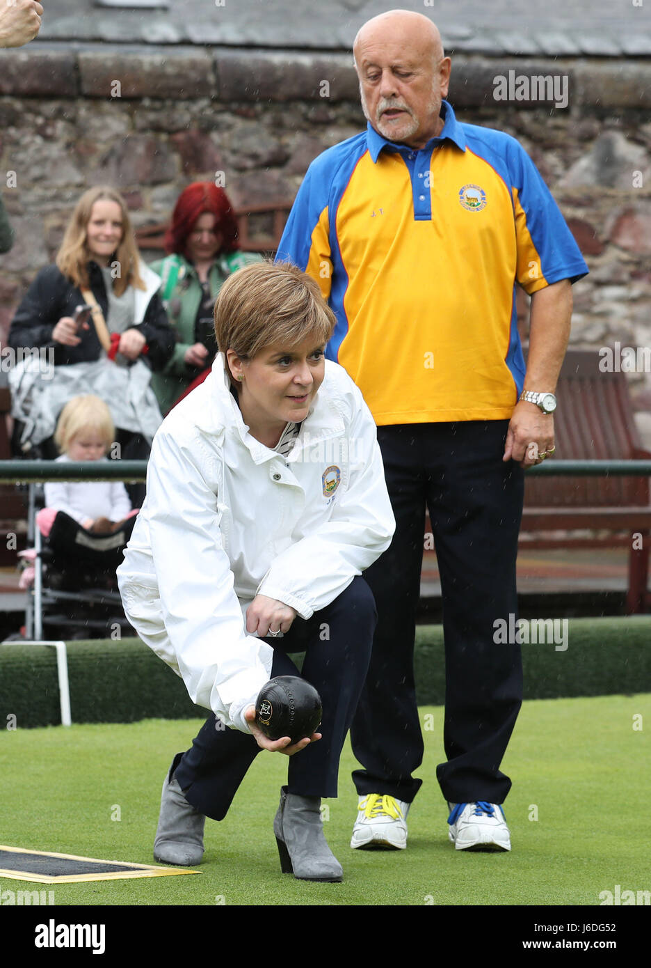 First Minister and SNP leader Nicola Sturgeon throws a bowl watched by ...