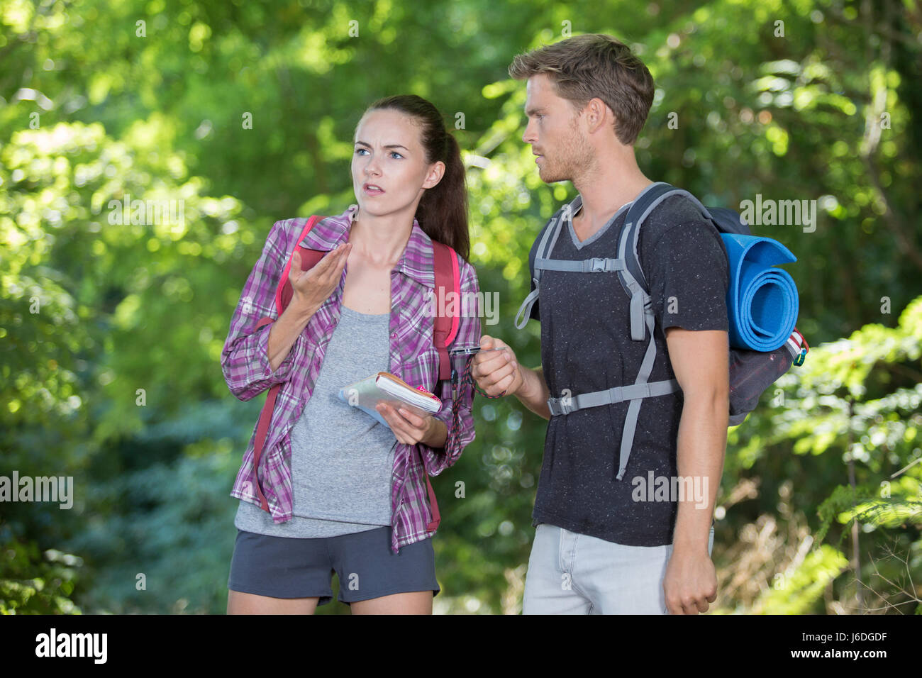 Couple of hikers looking lost Stock Photo - Alamy