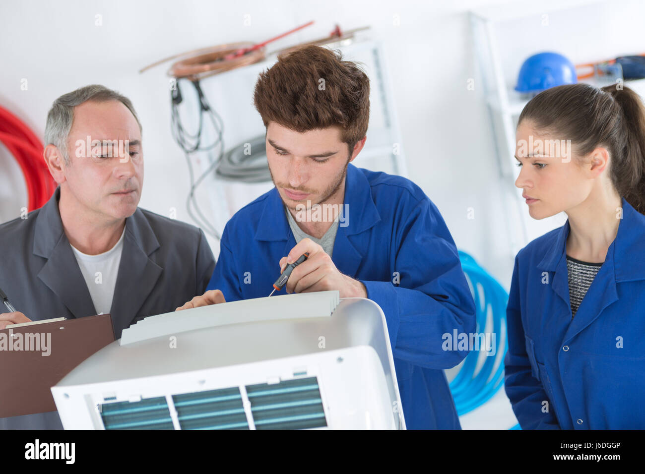 Young tradesman under supervision Stock Photo - Alamy