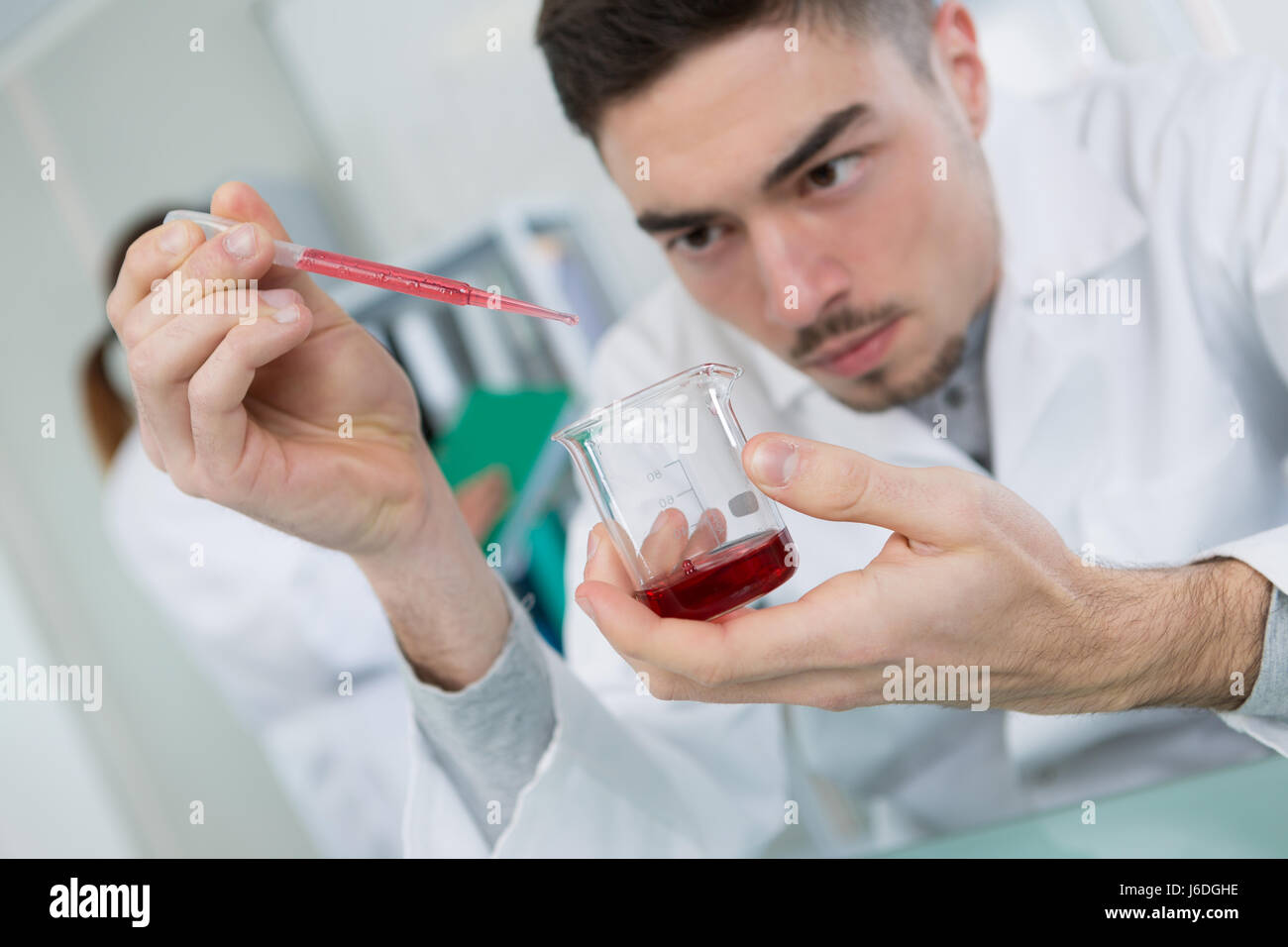 Male scientist using pipette Stock Photo - Alamy