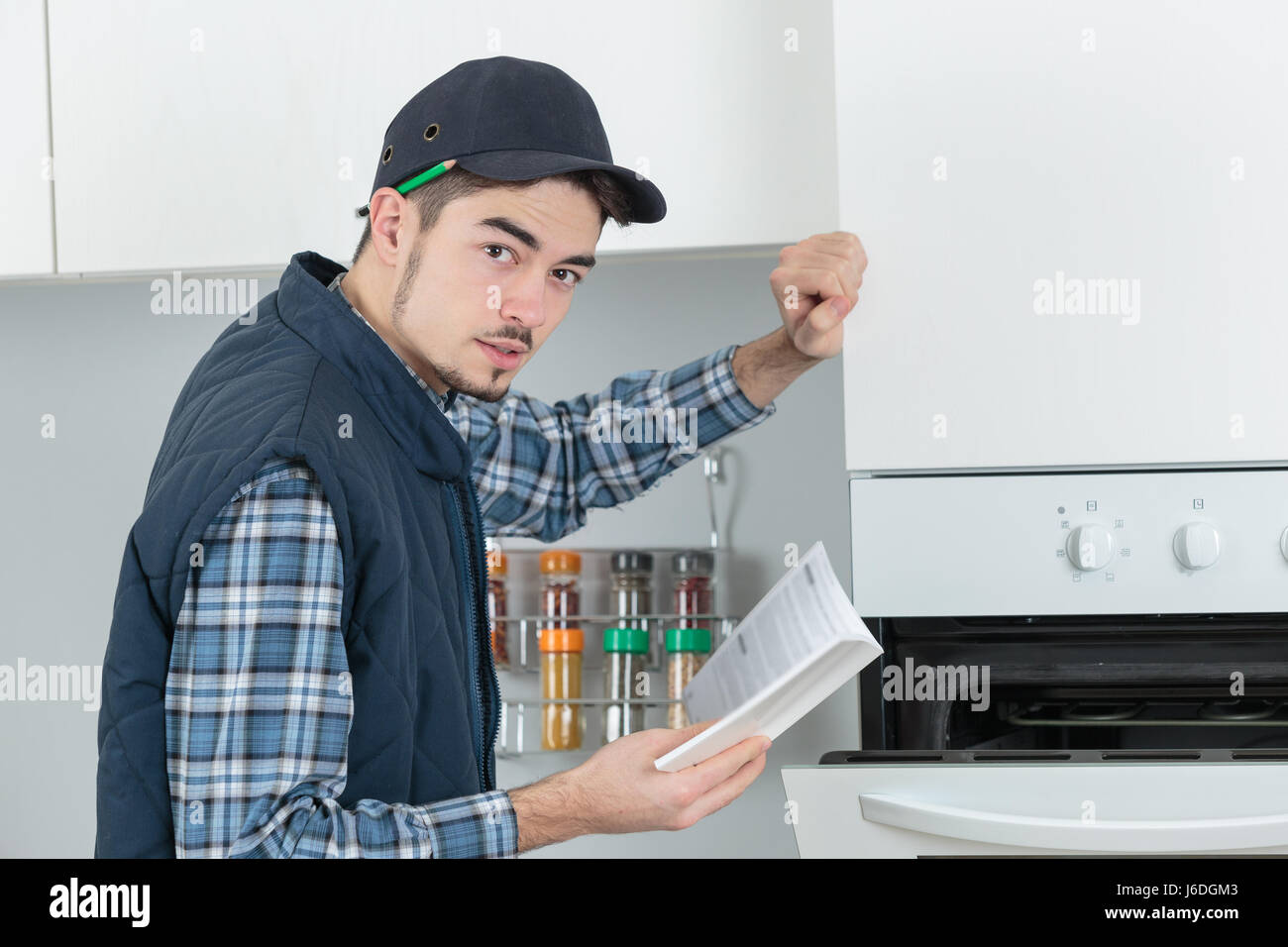 Contractor reading instructions for oven Stock Photo - Alamy