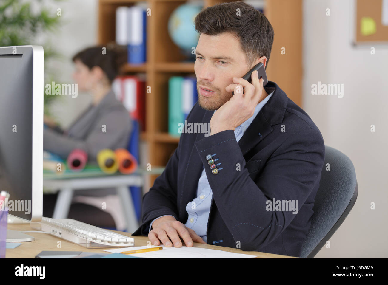 a man in an office with a computer at work Stock Photo - Alamy