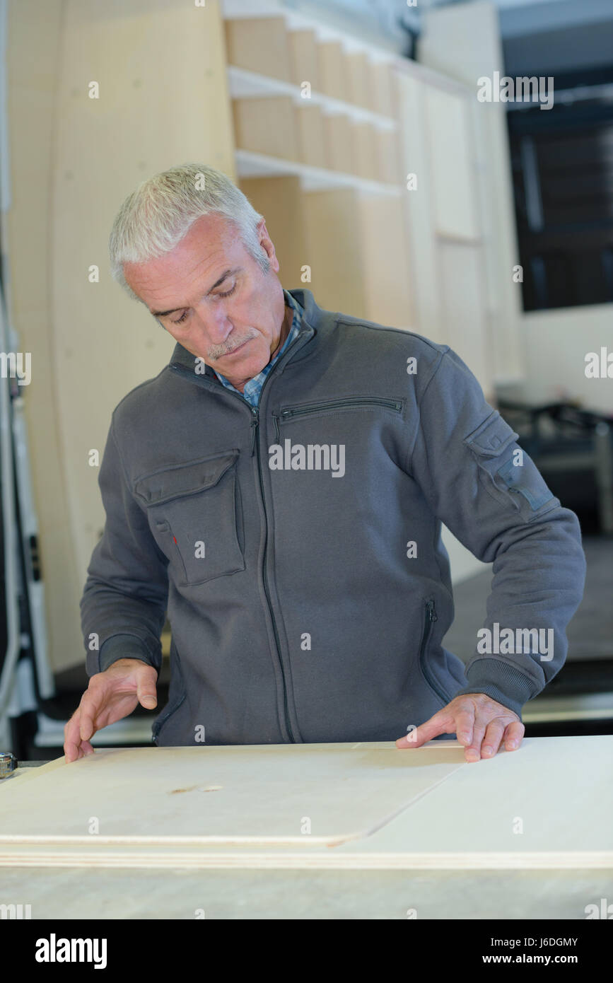 Senior worker in factory environment Stock Photo - Alamy