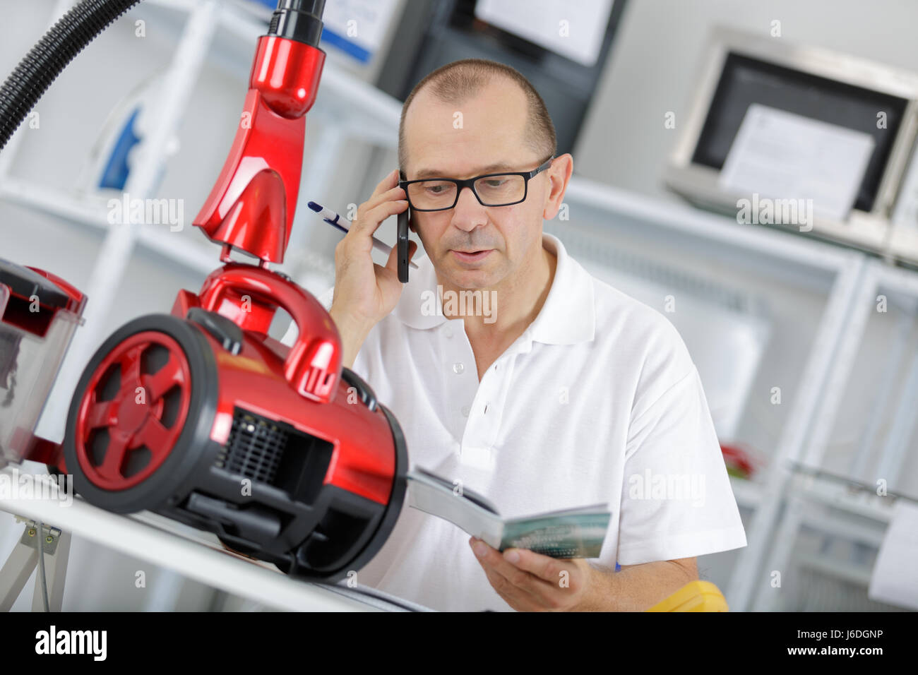 Man calling customer services about appliance Stock Photo - Alamy