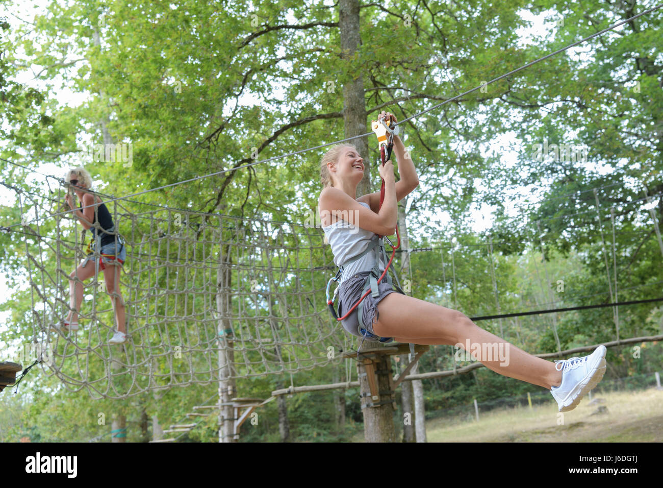 Woman on zip wire Stock Photo - Alamy