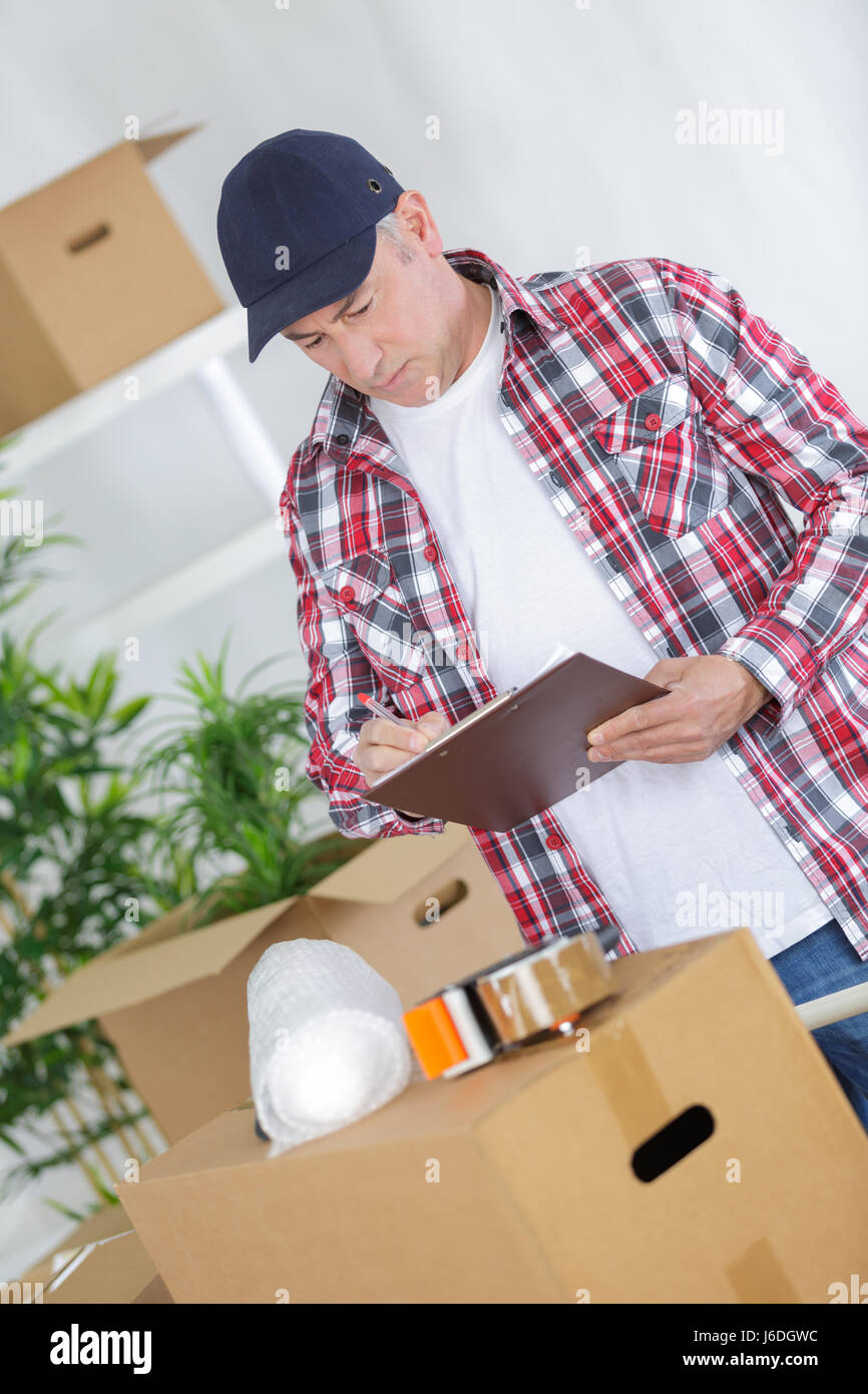 Man with clipboard checking off boxes Stock Photo - Alamy