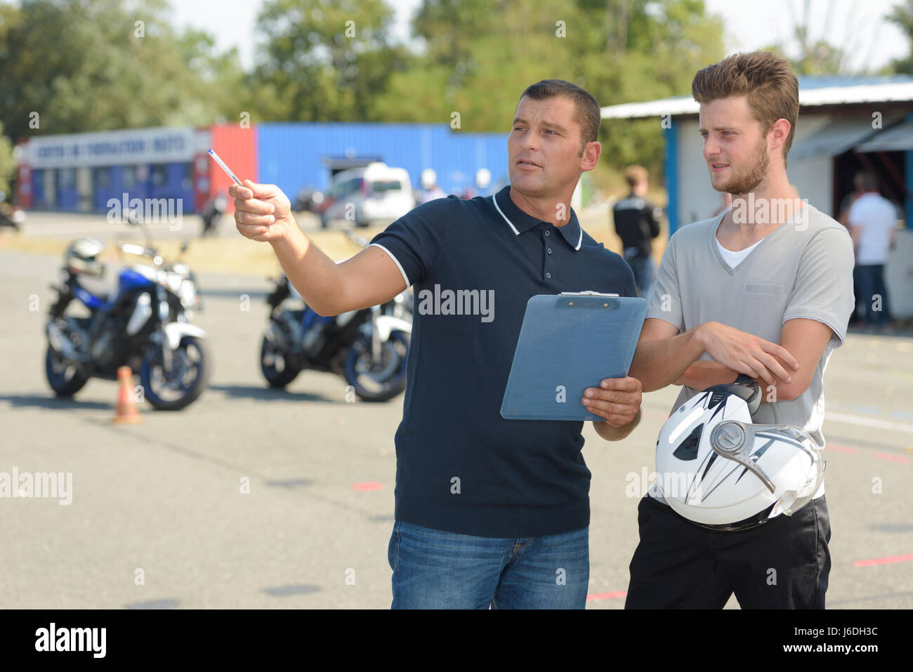 Man receiving instructions at motorcycle training course Stock Photo ...