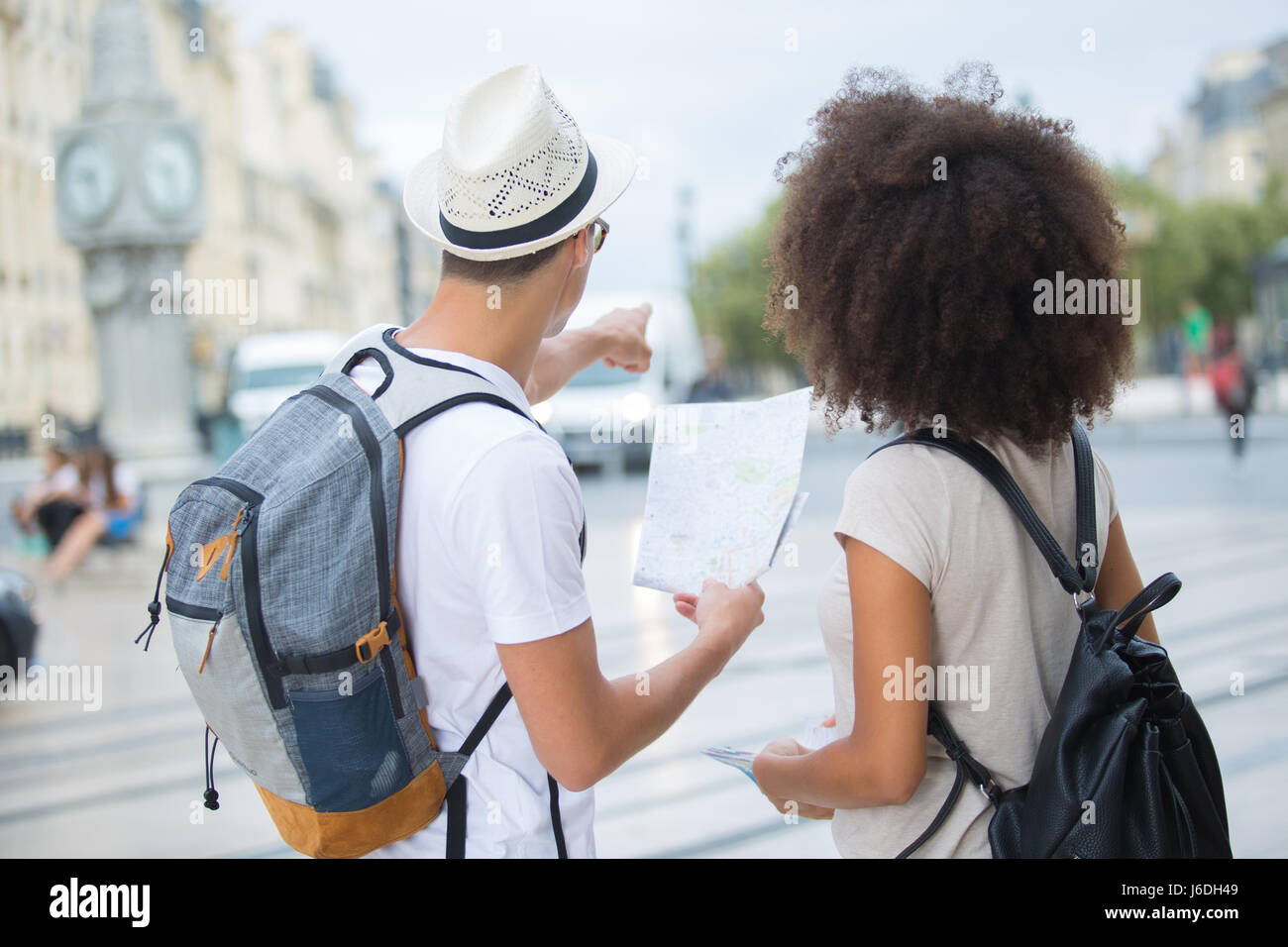 Tourists holding map and pointing into distance Stock Photo - Alamy