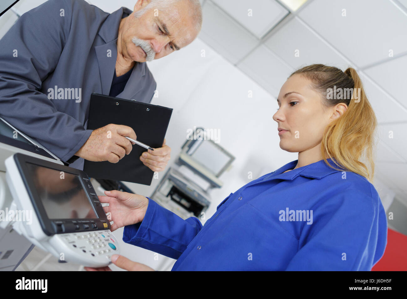 Woman using photocopier keypad Stock Photo - Alamy