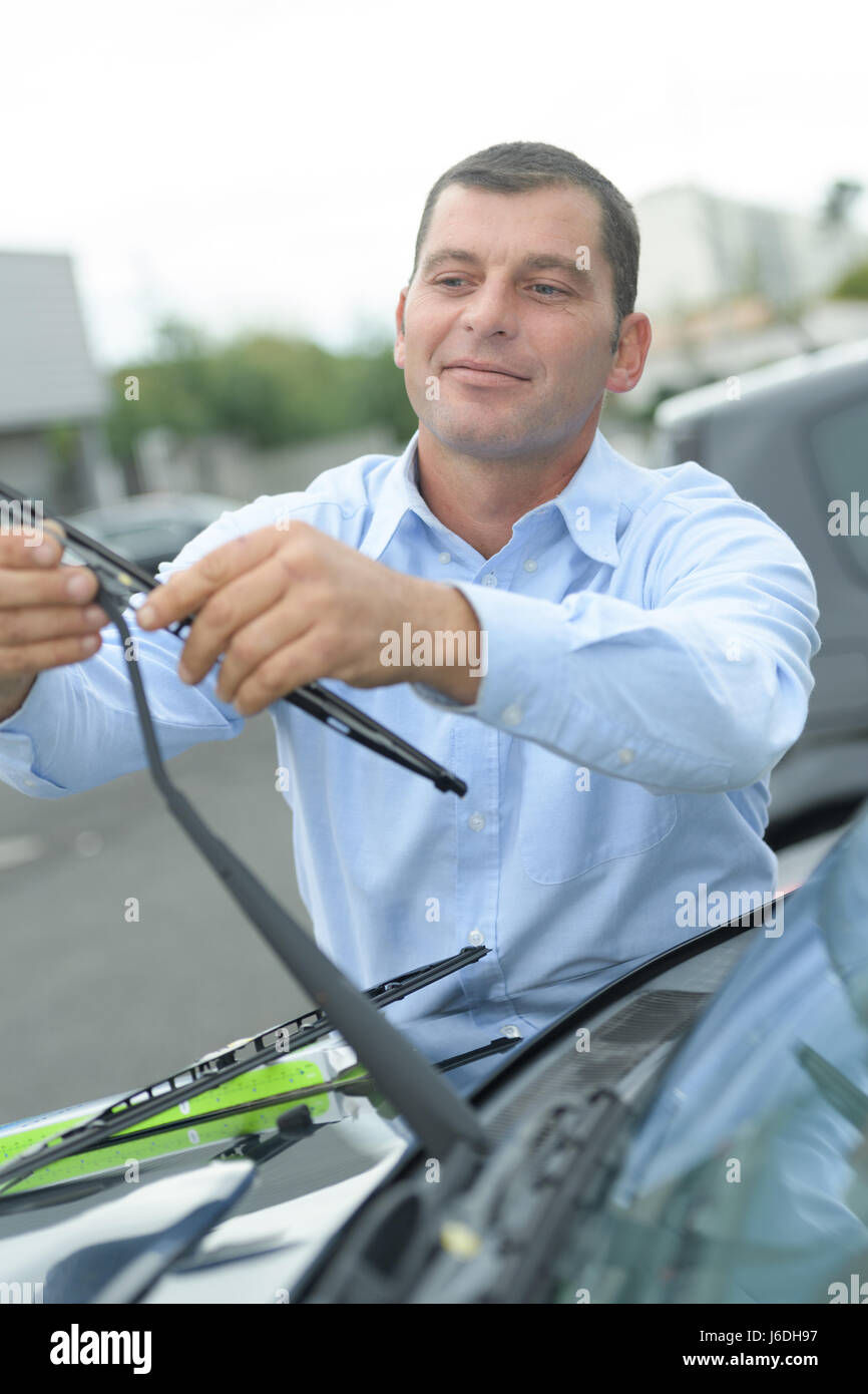 Man replacing wiper blade Stock Photo - Alamy