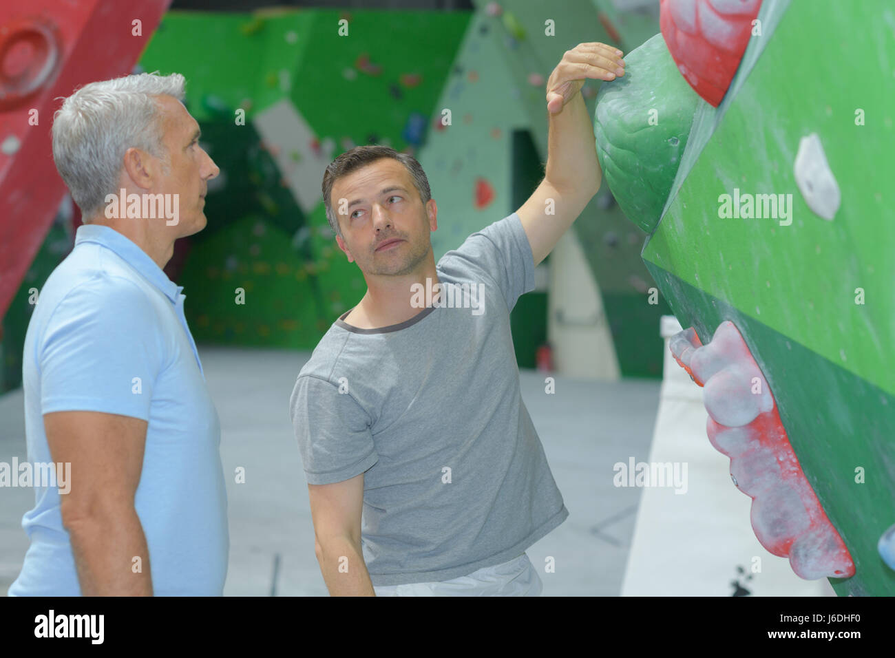 Men looking at indoor climbing structure Stock Photo - Alamy
