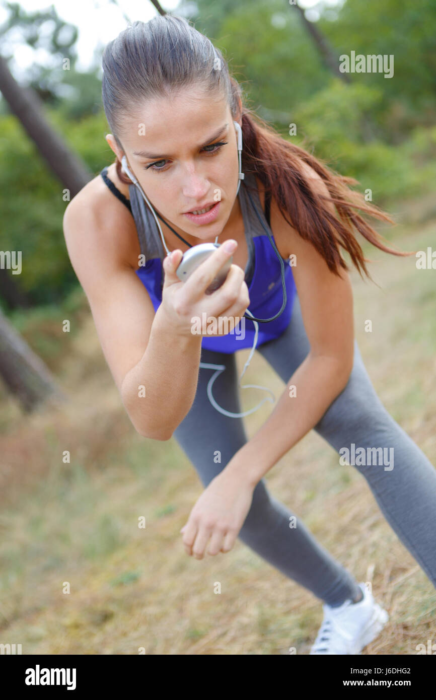 Poised lady with stopwatch Stock Photo - Alamy