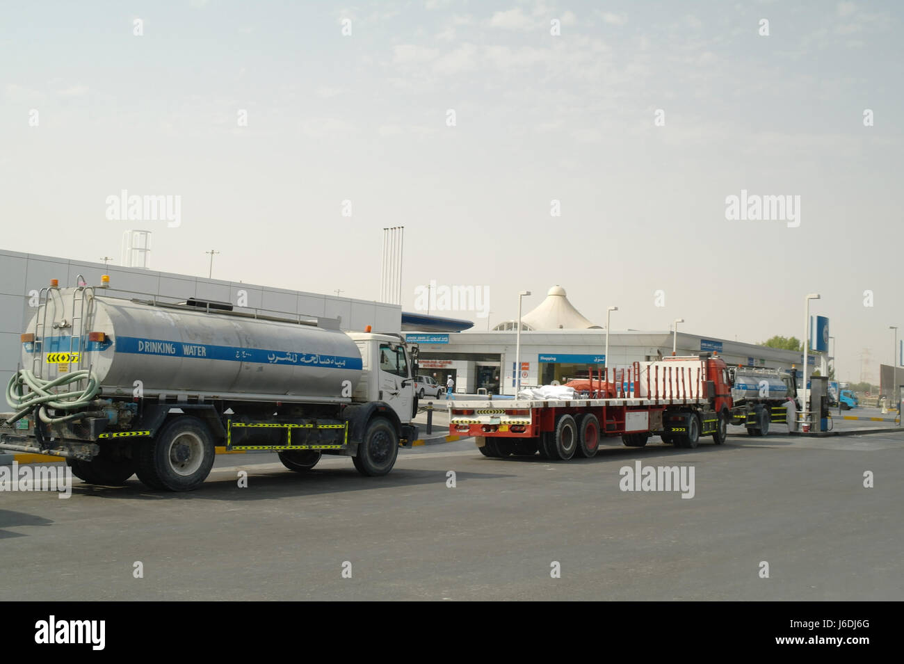 Lorries, including two drinking water tankers, queuing for fuel, Adnoc ...