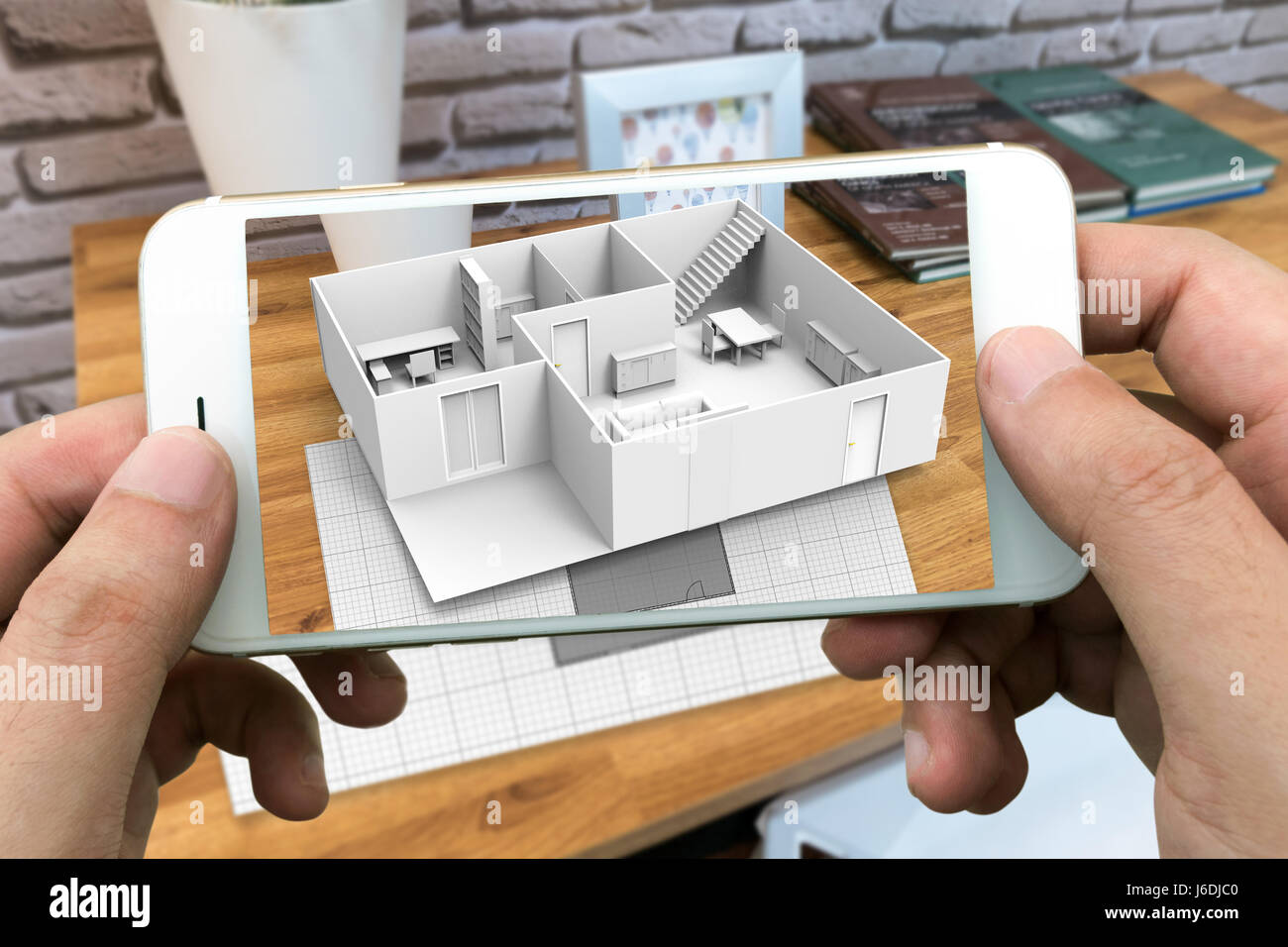 Augmented reality marketing concept for architecture. Hand holding smart phone using AR ...