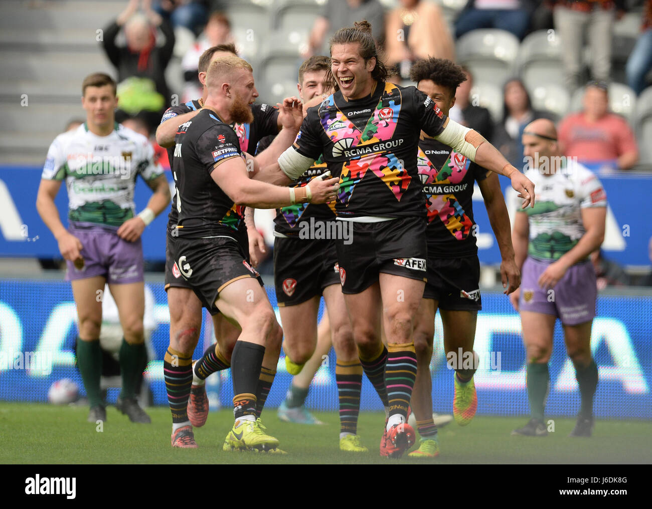 St Helens' Louie McCarthy Scarsbrook (right) celebrates after scoring a ...