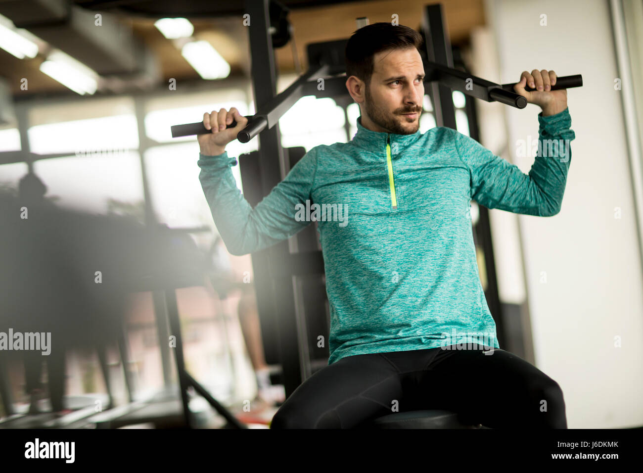 Young man exercise on an exercise machine at the gym Stock Photo - Alamy