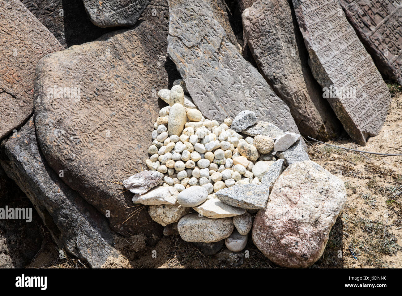 Scripture, mantras and pebble offerings around a stuppe in Nepal Stock ...