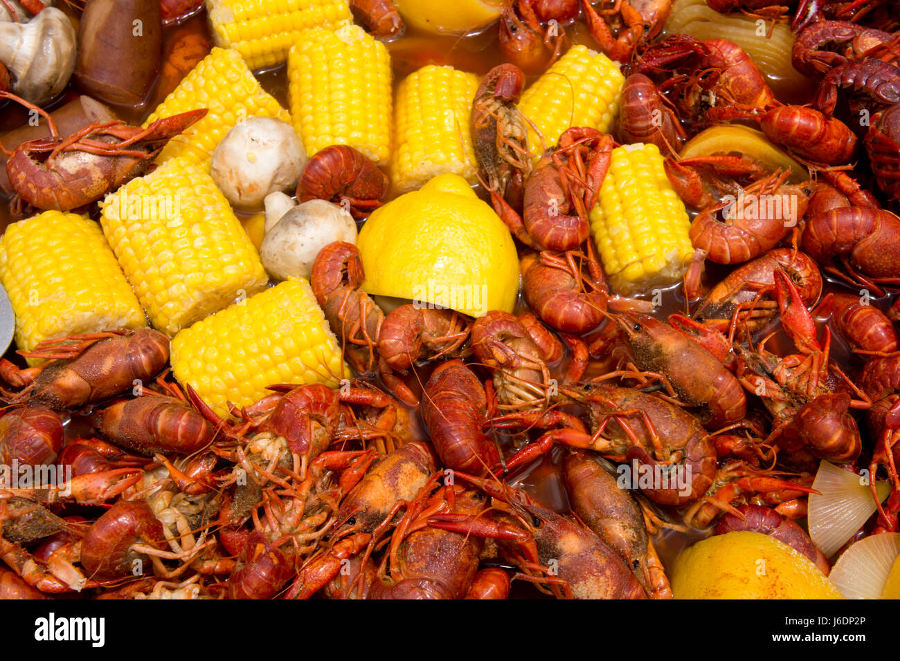 Boiled crayfish and corn on the cob in New Orleans. Southern cuisine ...