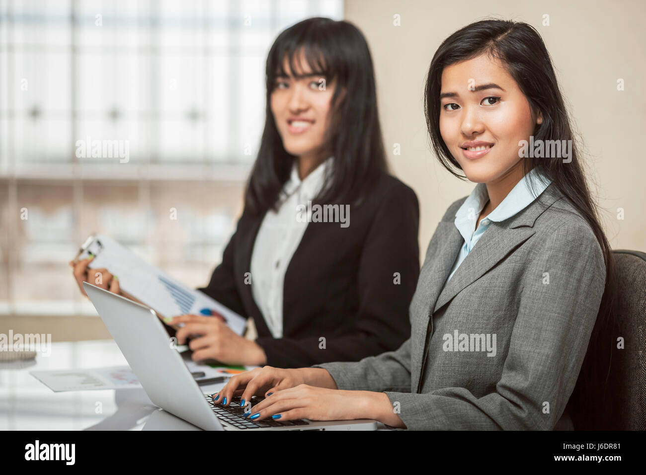 smiling women employees who does customer services Stock Photo - Alamy