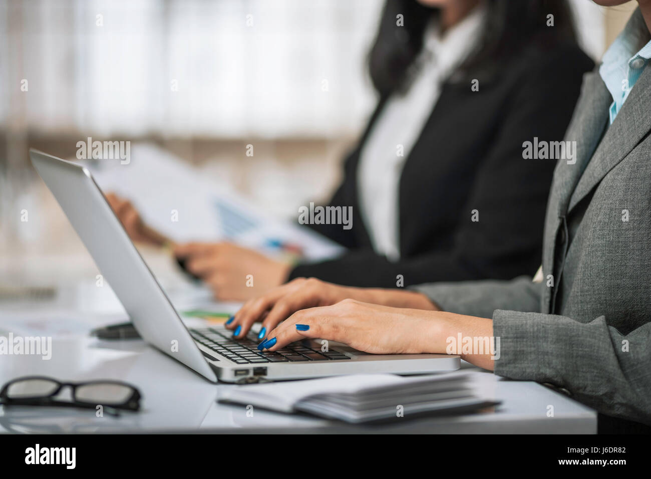 women employees typing on the laptop computer Stock Photo - Alamy