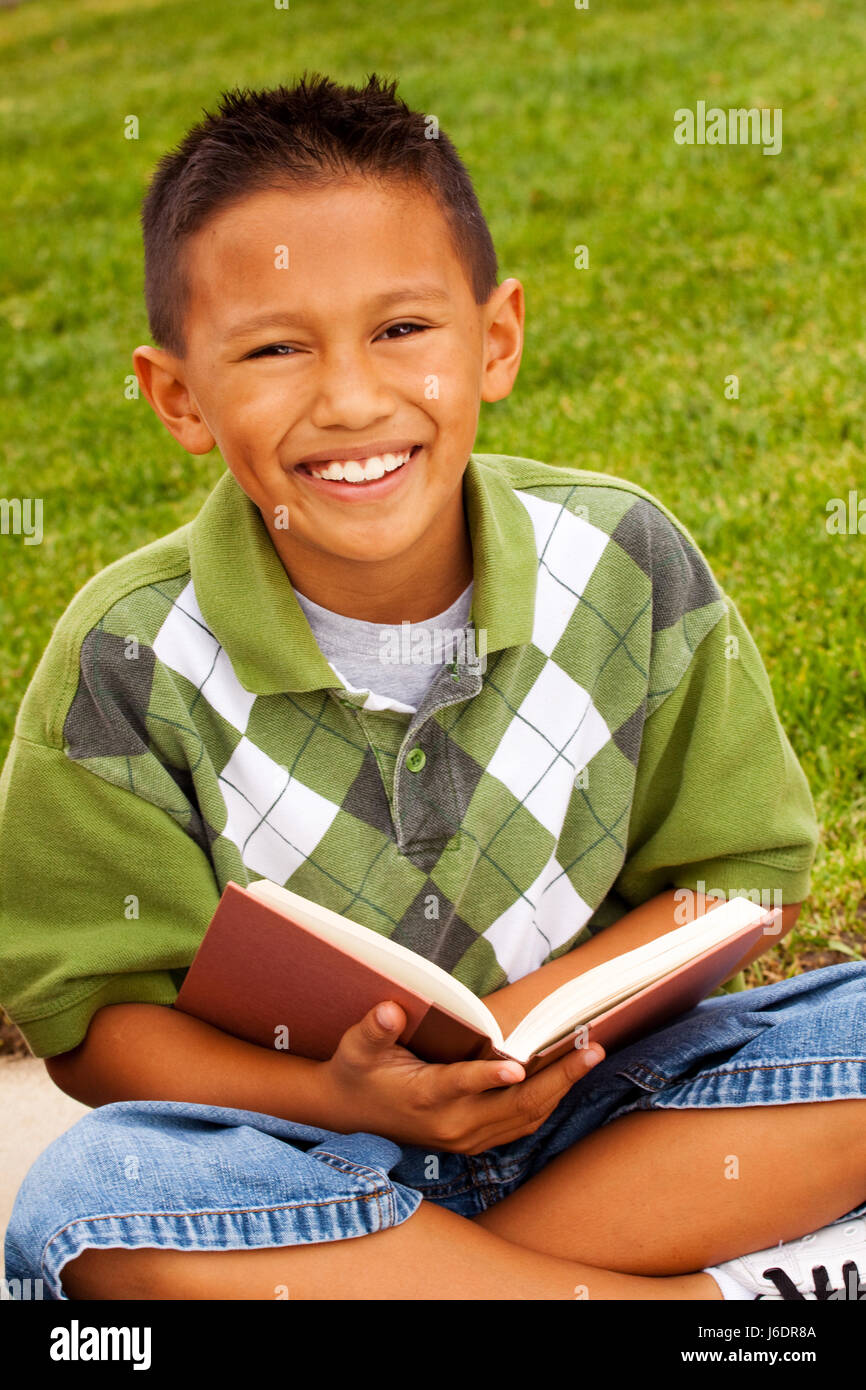 Happy young kids smiling and reading Stock Photo - Alamy