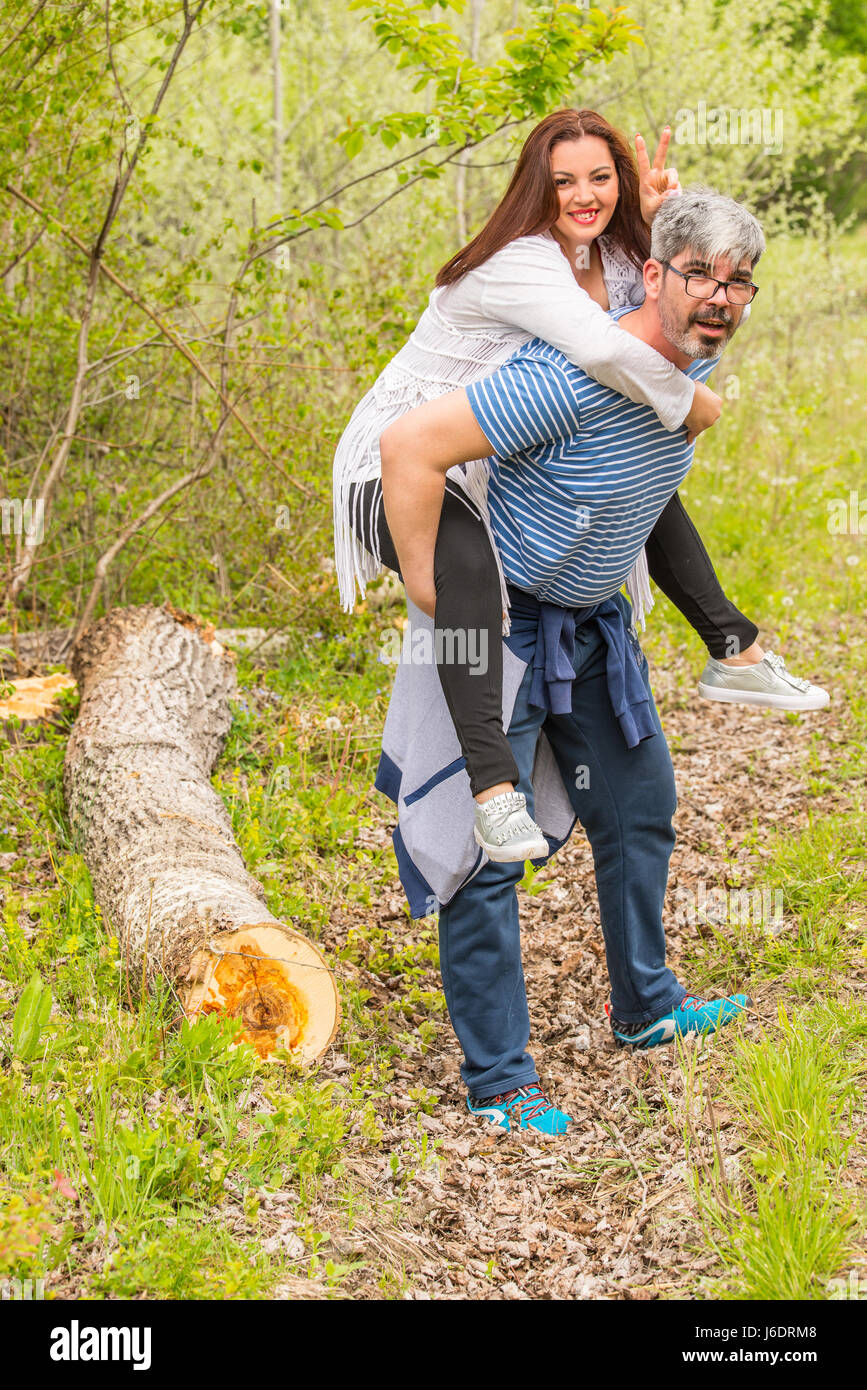 Man and woman having fun and husband giving piggyback to his wife Stock ...