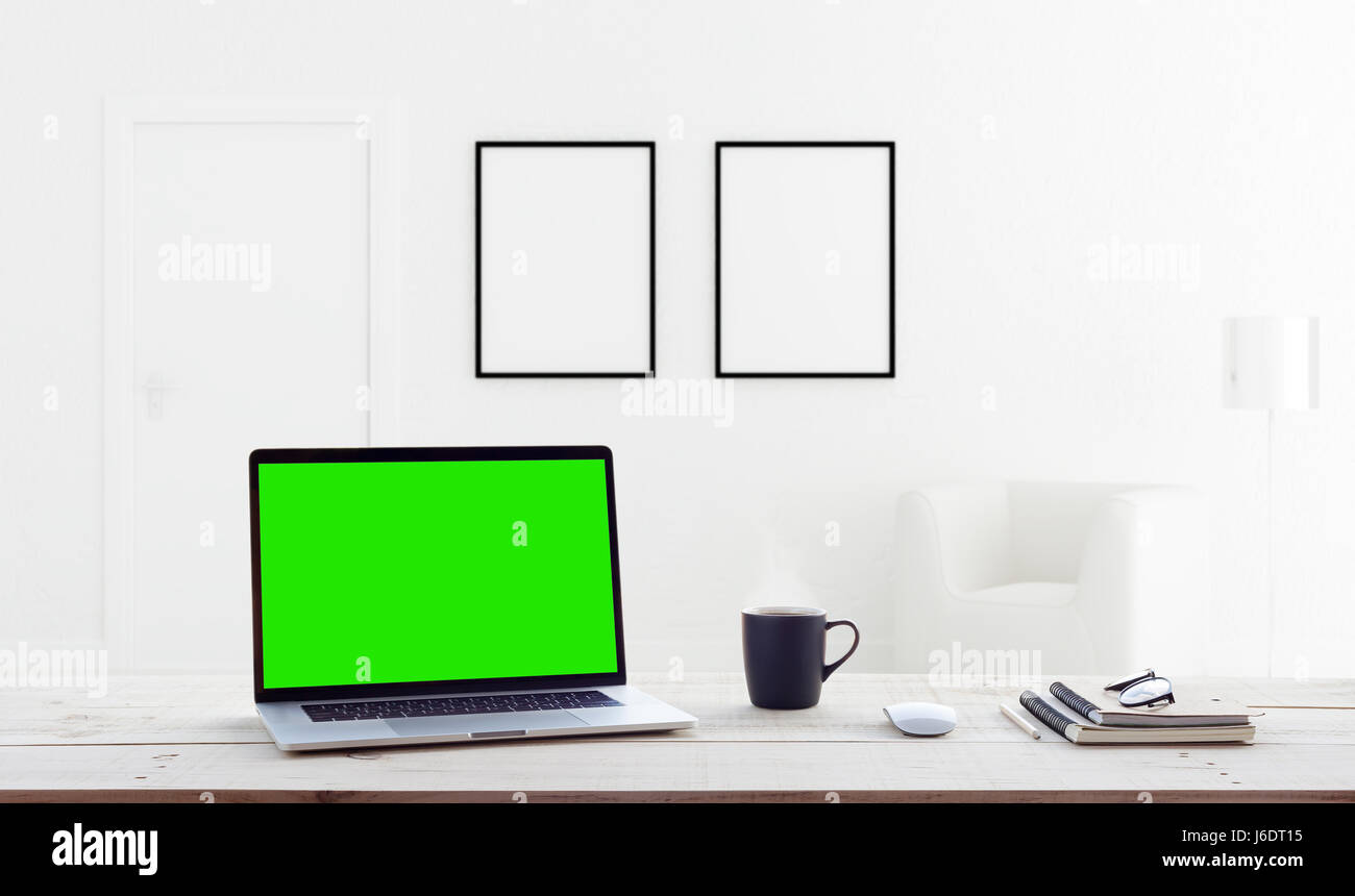 laptop computer showing green screen in home interior background Stock ...