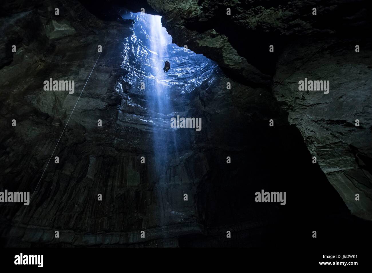 A potholer descends on a winch into Gaping Gill, the largest cavern in ...