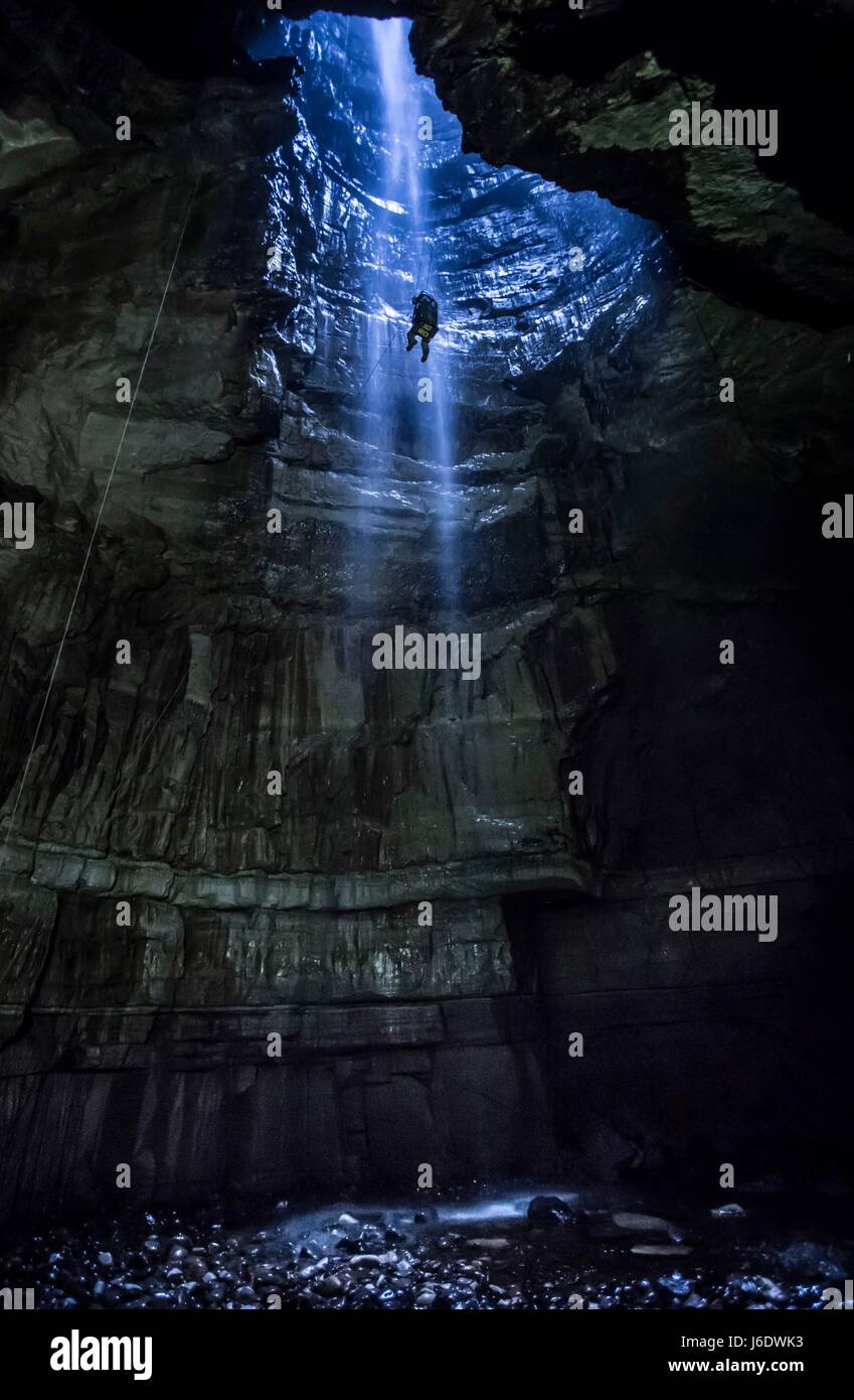 A potholer descends on a winch into Gaping Gill, the largest cavern in ...