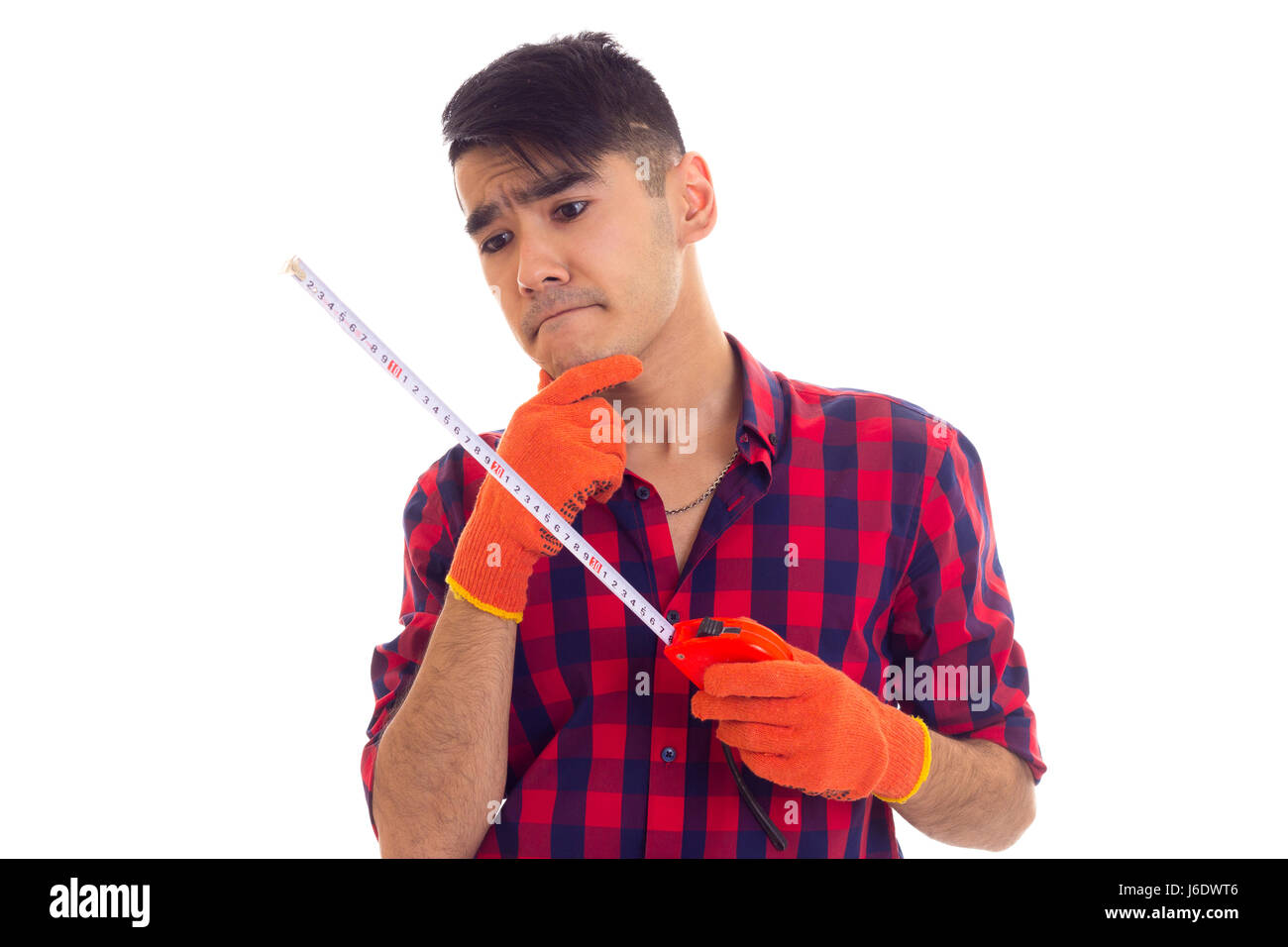 Young man in gloves holding tape-measure Stock Photo - Alamy
